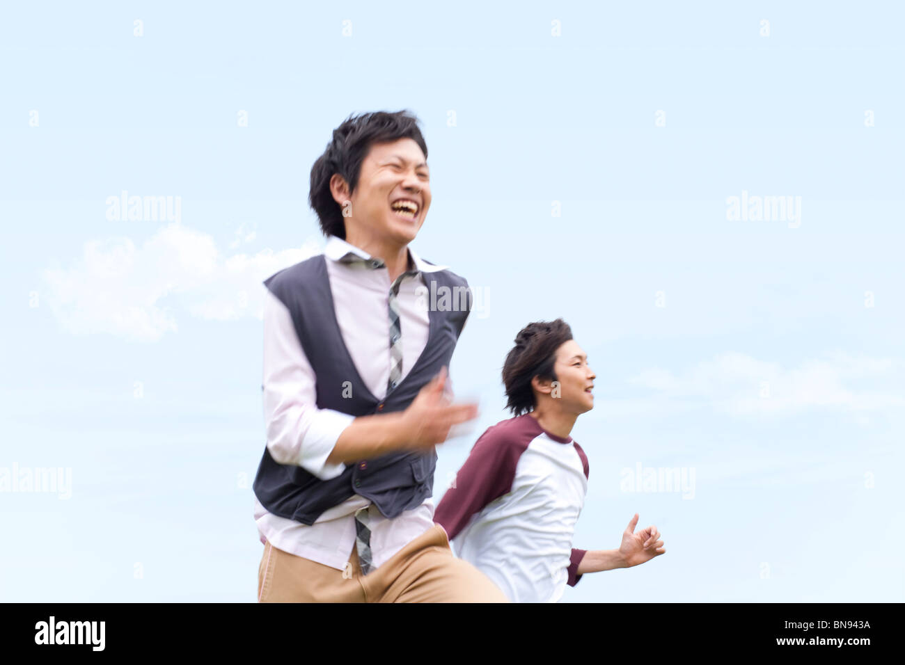 Two young men running Stock Photo - Alamy