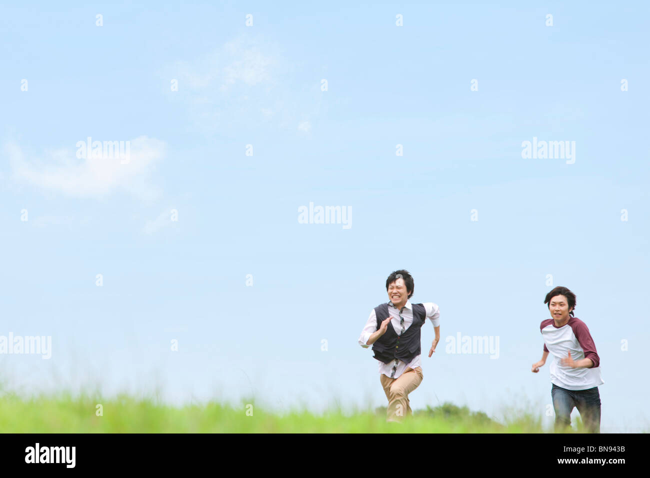 Two young men running Stock Photo - Alamy