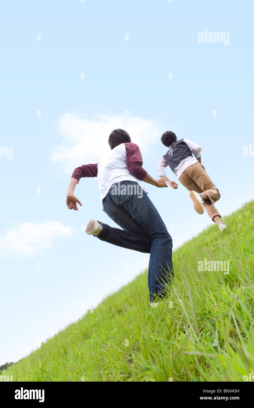 Two young men running Stock Photo - Alamy