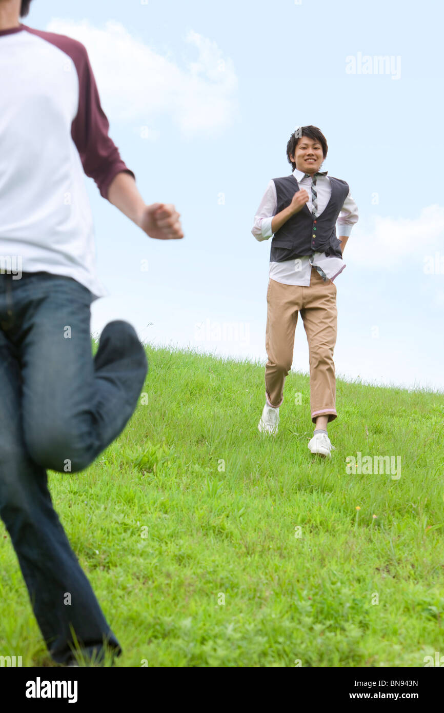 Two young men running Stock Photo - Alamy