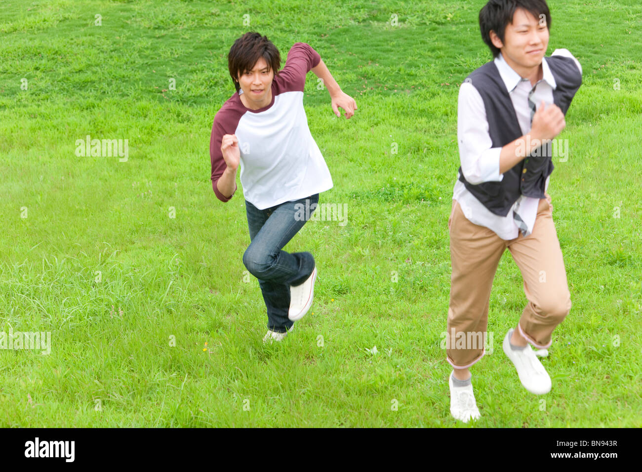 Two young men running Stock Photo - Alamy