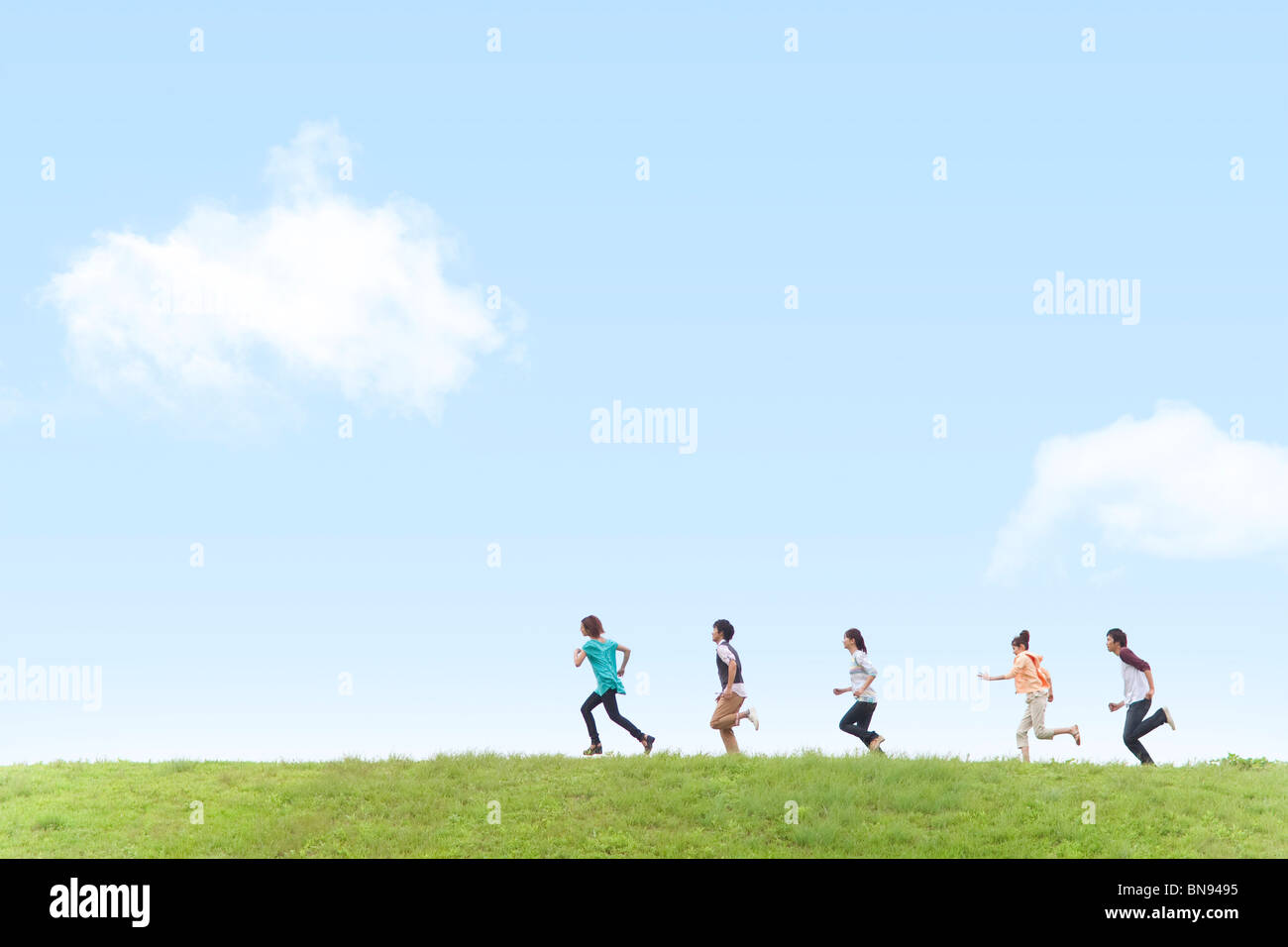 Young Men and Women Running in Line Stock Photo - Alamy
