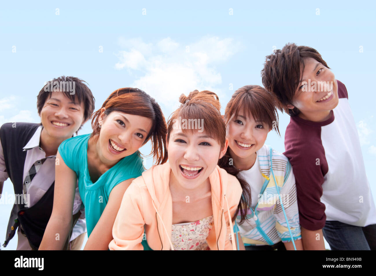 Portrait of five young people under sky smiling Stock Photo - Alamy