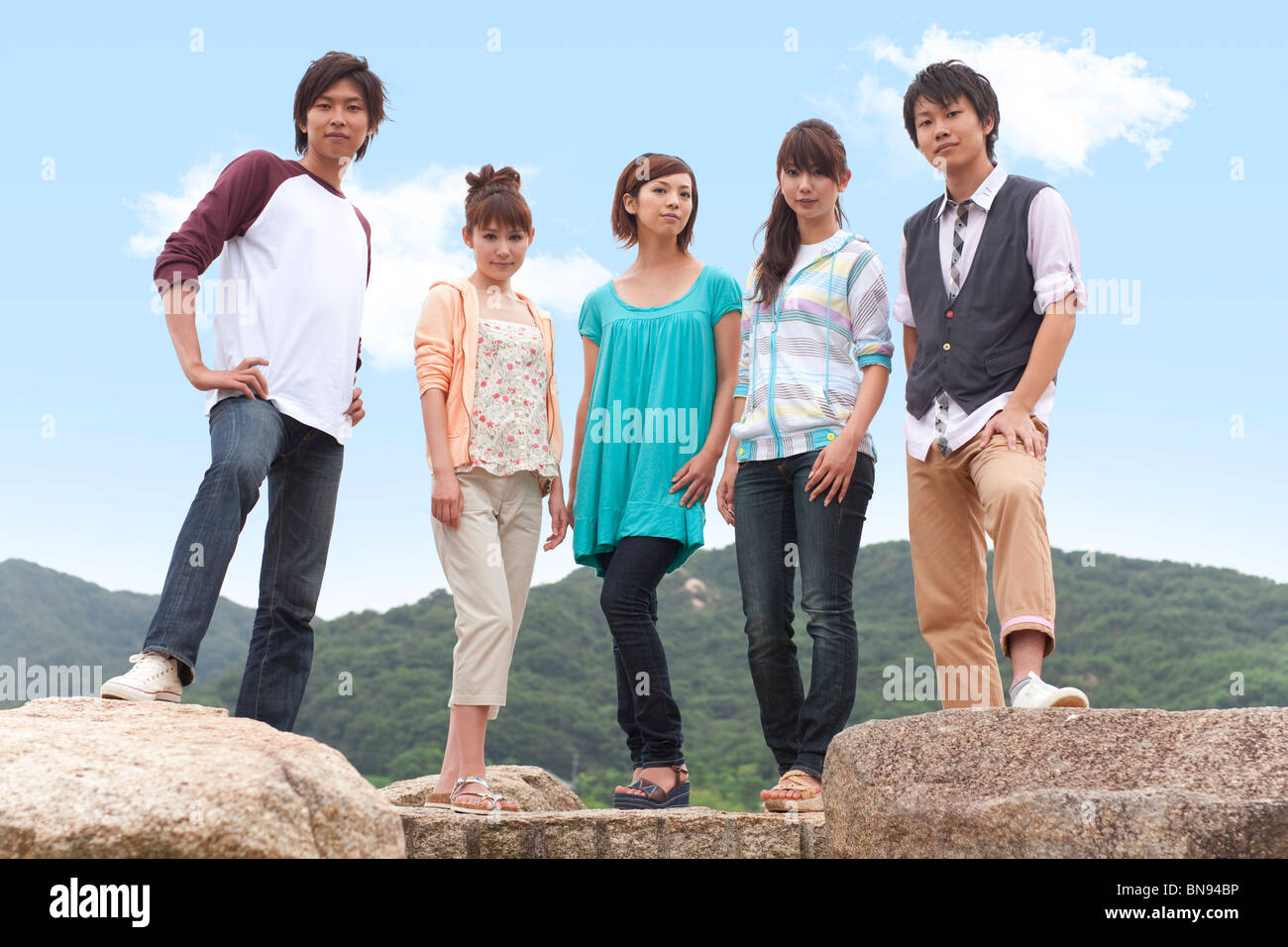 Portrait of five young people standing on rocks Stock Photo - Alamy