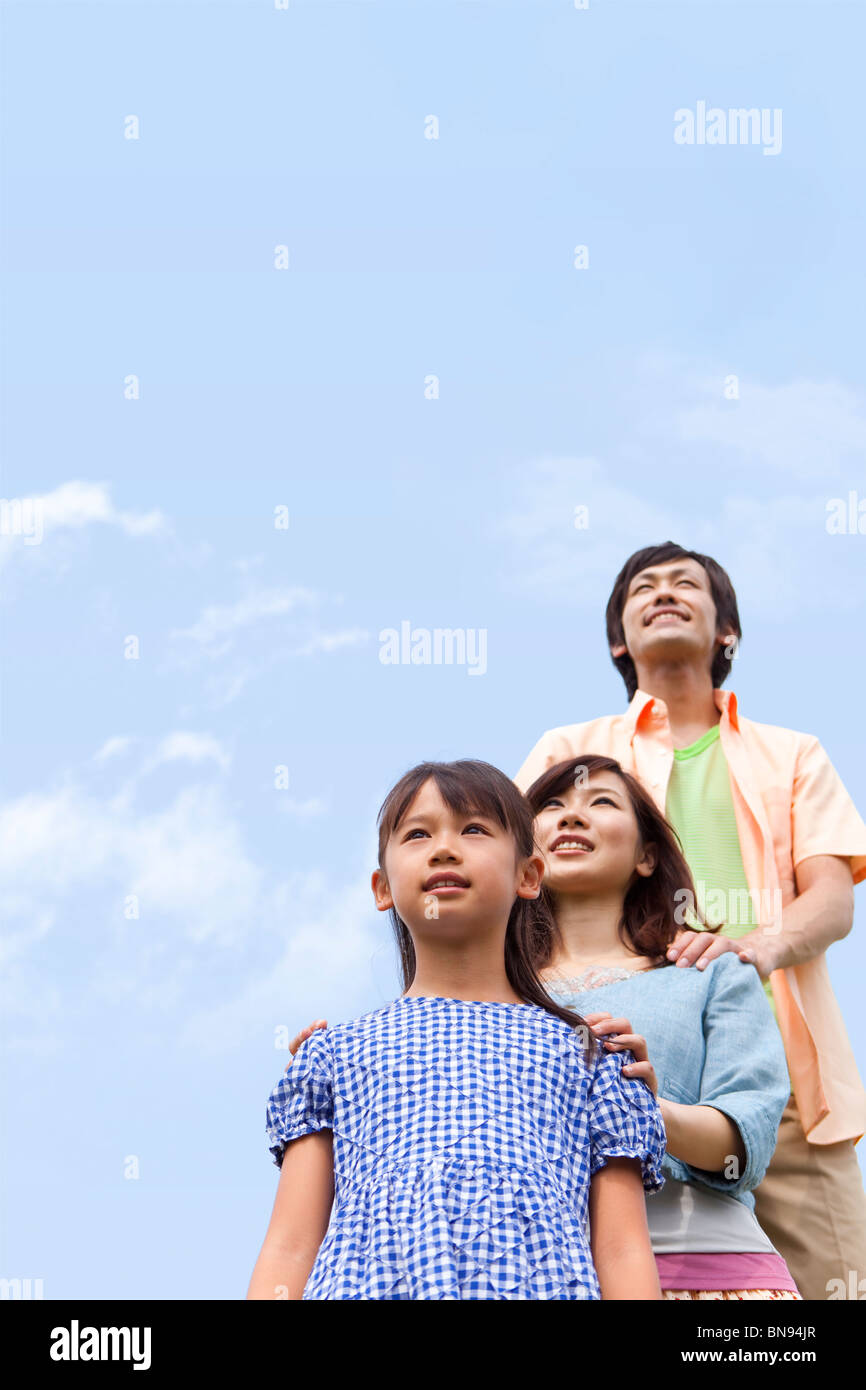 Family looking up at sky smiling copy space Stock Photo - Alamy