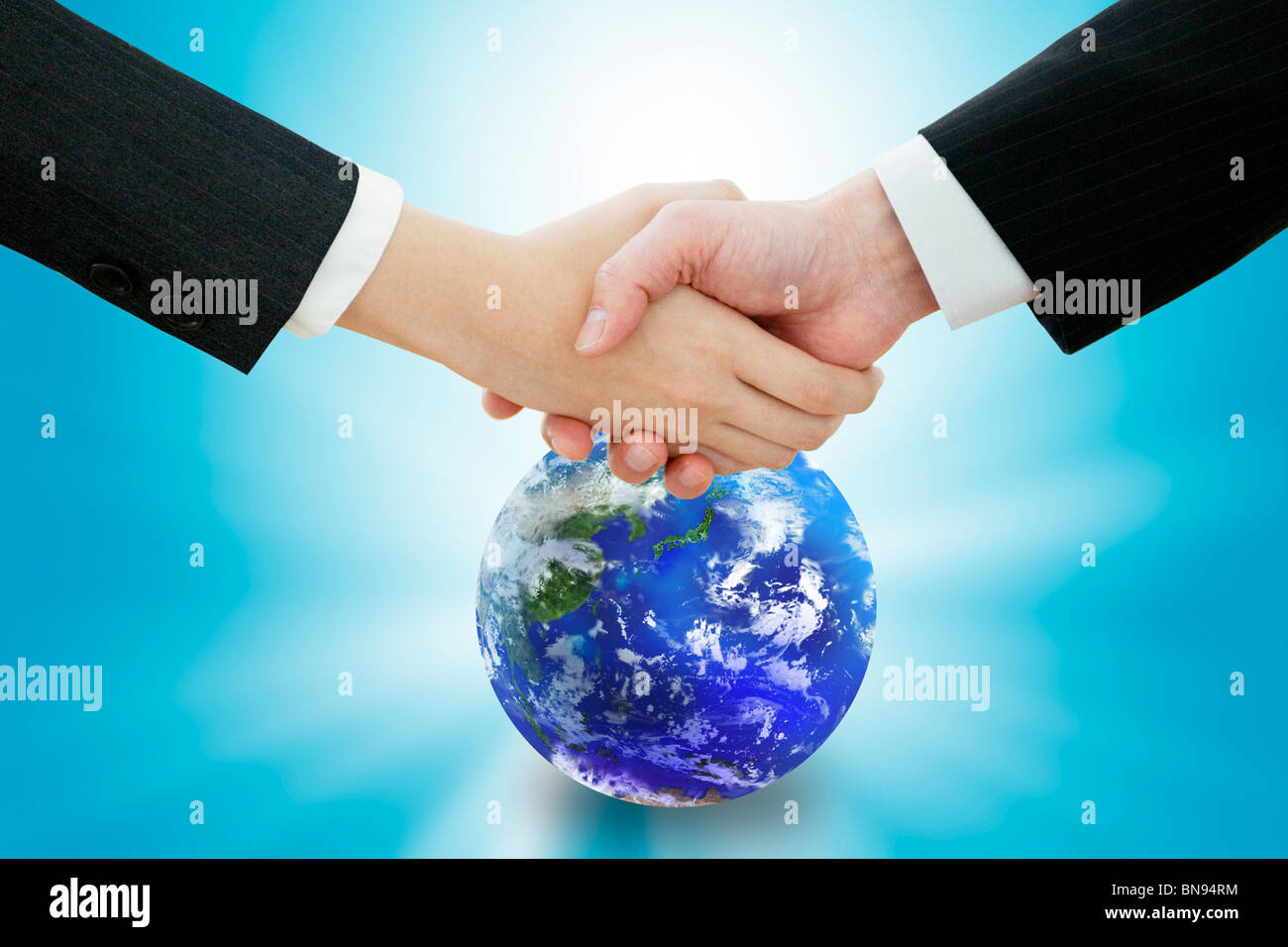 Businessman and businesswoman shaking hands the earth on background ...
