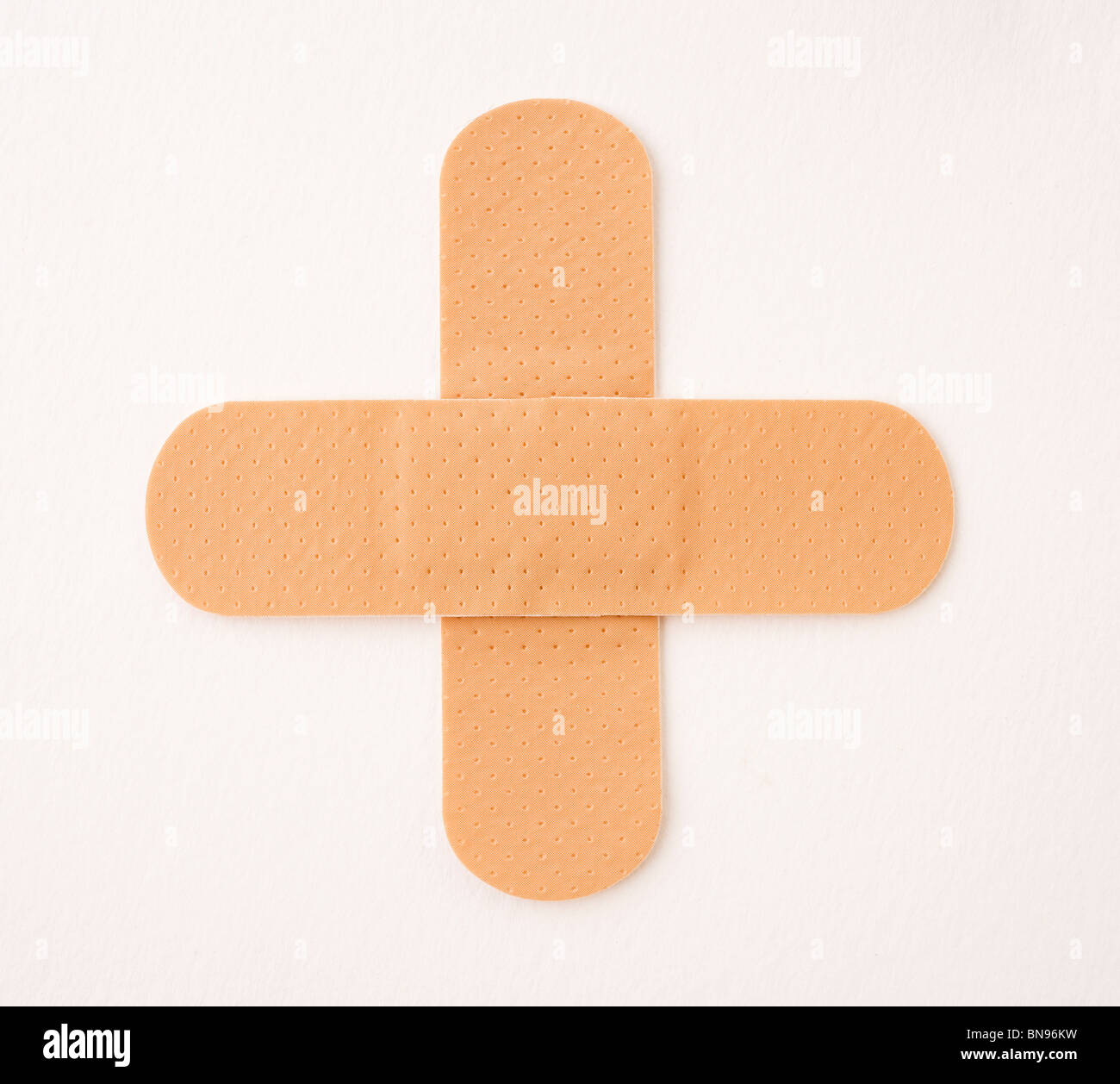 Medical cross made from two plasters isolated on white Stock Photo - Alamy