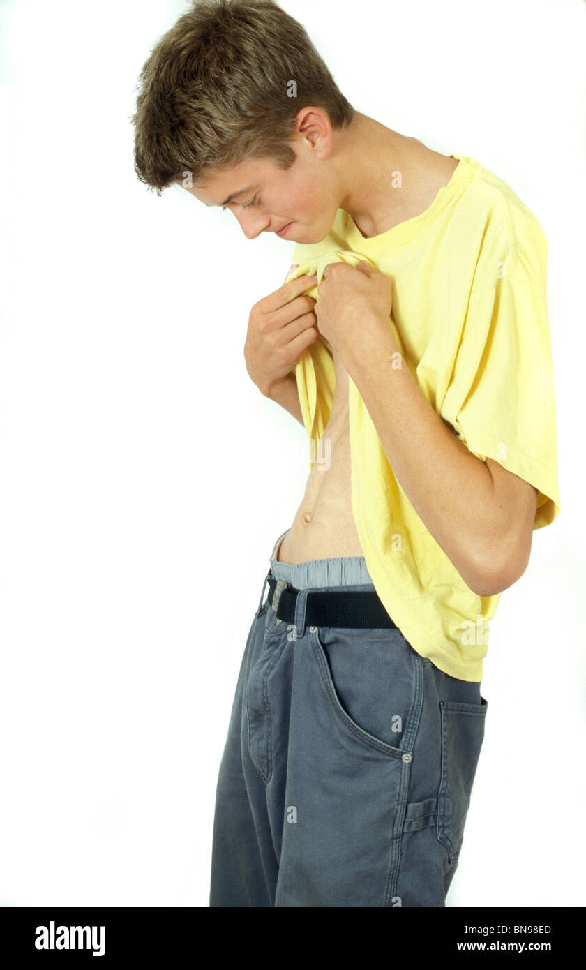 Thin anorexic looking teenage boy looking at his body Stock Photo - Alamy