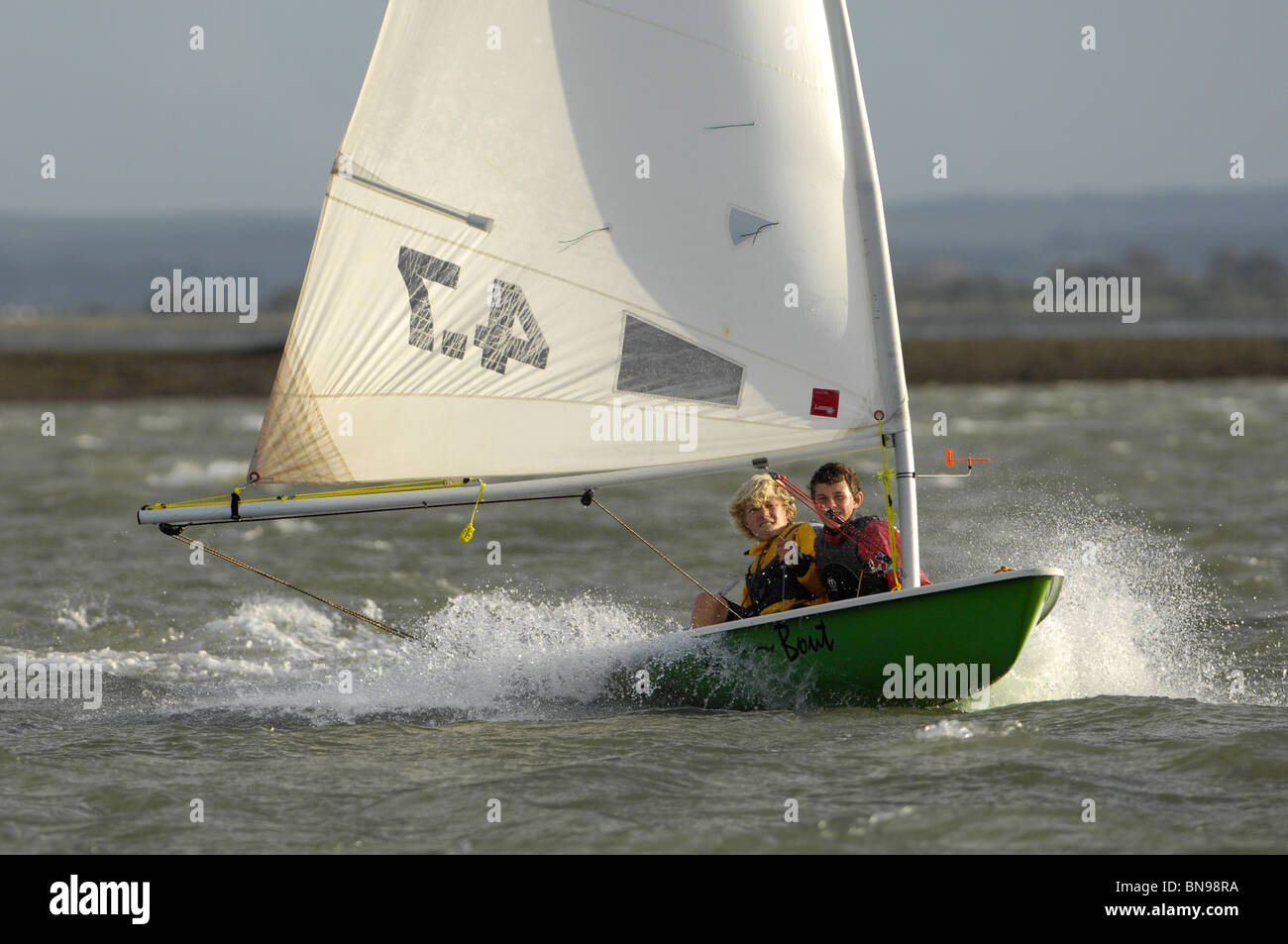 Two young boys sailing a Laser yacht in 18 knots of breeze on the River ...