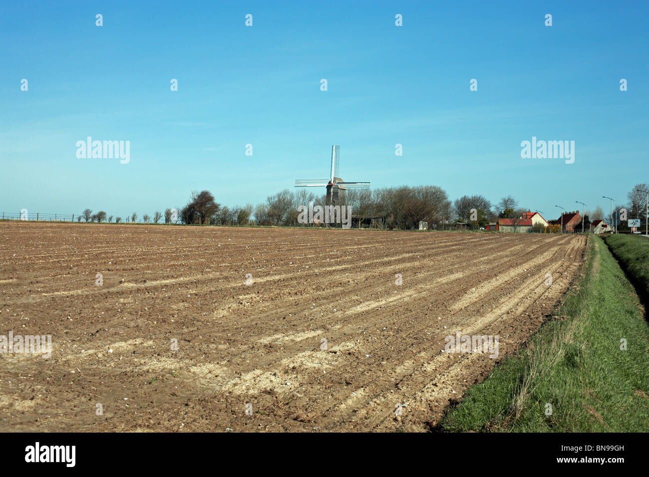 View of the Moulin de Coquelles from across fields during early spring ...