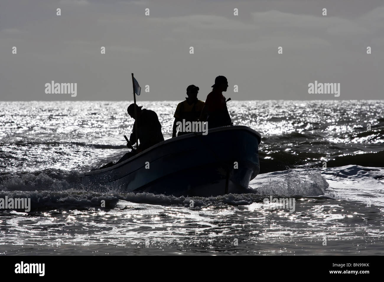 three fishermen in his boat with dramatic lighting (backlight Stock ...