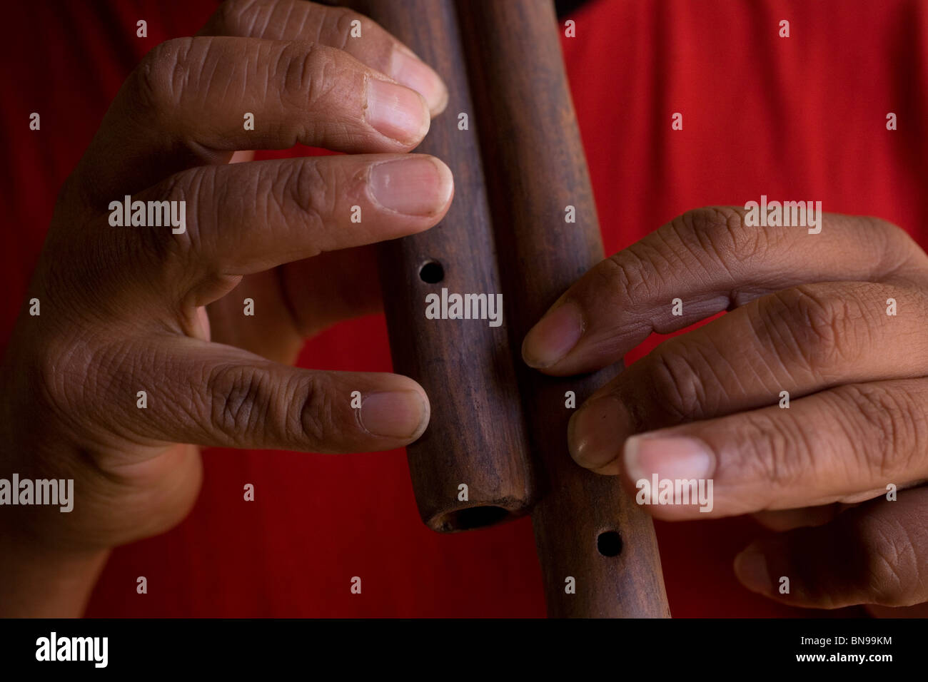 A musician plays a double flute, an Mesoamerican Pre-Hispanic musical ...
