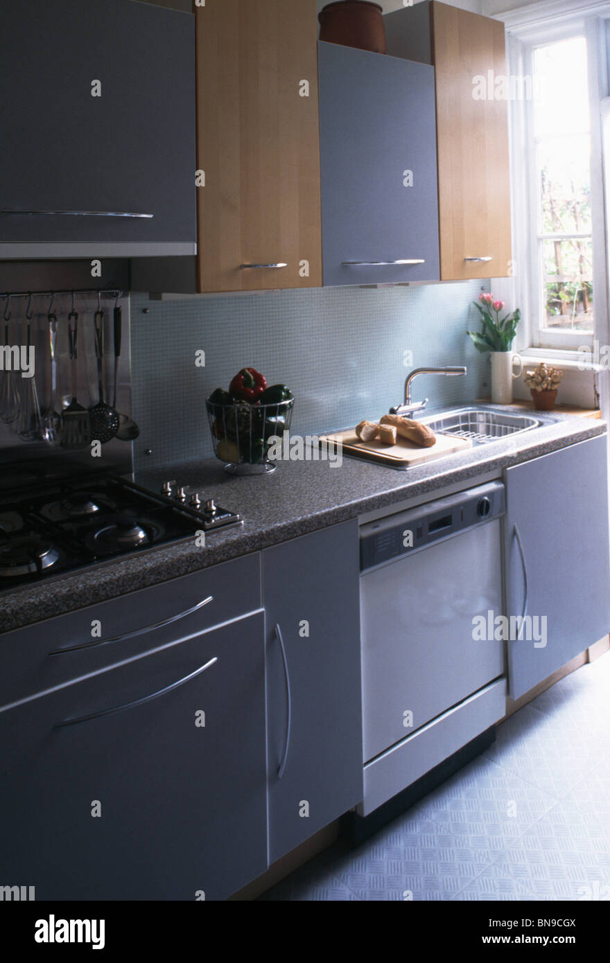 Fitted grAy units in small modern kitchen Stock Photo - Alamy