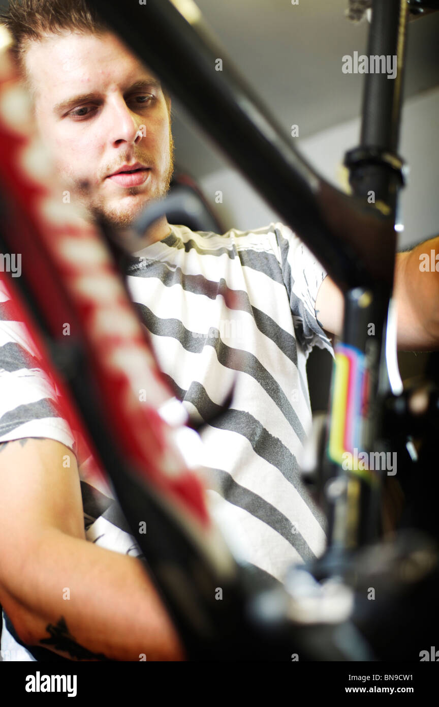 Cycle mechanic fixing racing bike in workshop Stock Photo - Alamy