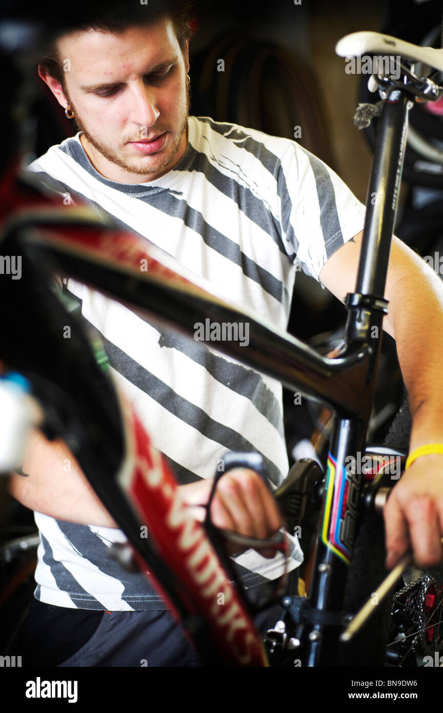 Cycle Mechanic fixing bike Stock Photo - Alamy