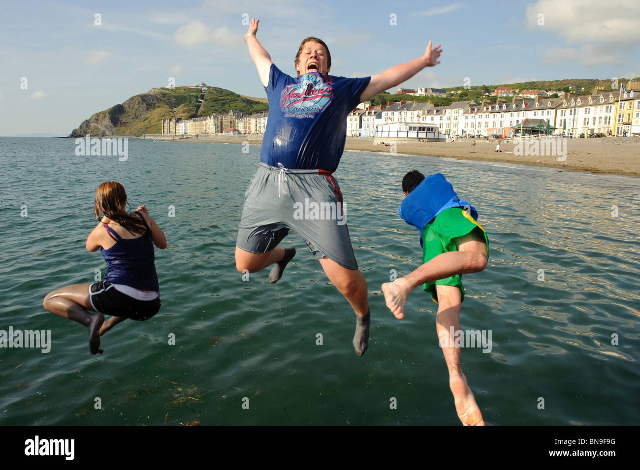 Three Kids Jumping On The Beach High Resolution Stock Photography and ...