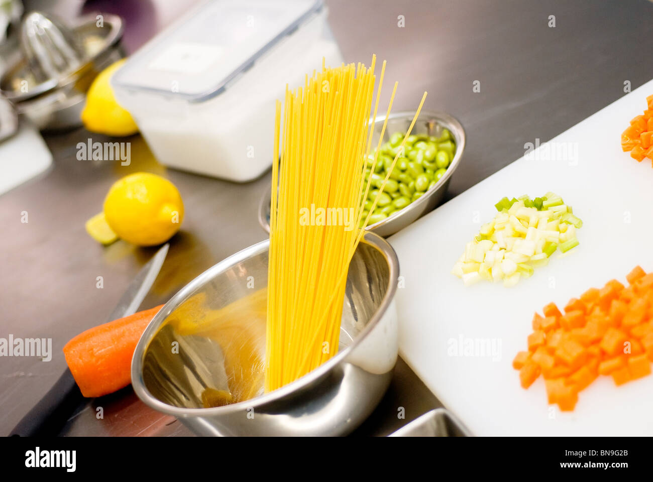 italian spaghetti pasta on a typical full equipped restaurant kitchen ...
