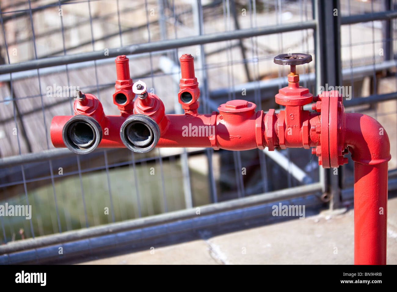 red steel fireplug pipe on a street. horizontal shot Stock Photo - Alamy