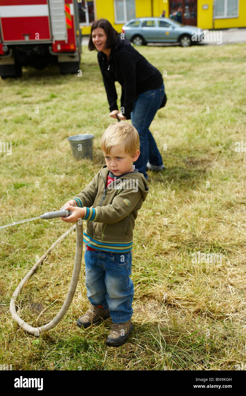 Young child boy playing fire fighter Stock Photo - Alamy