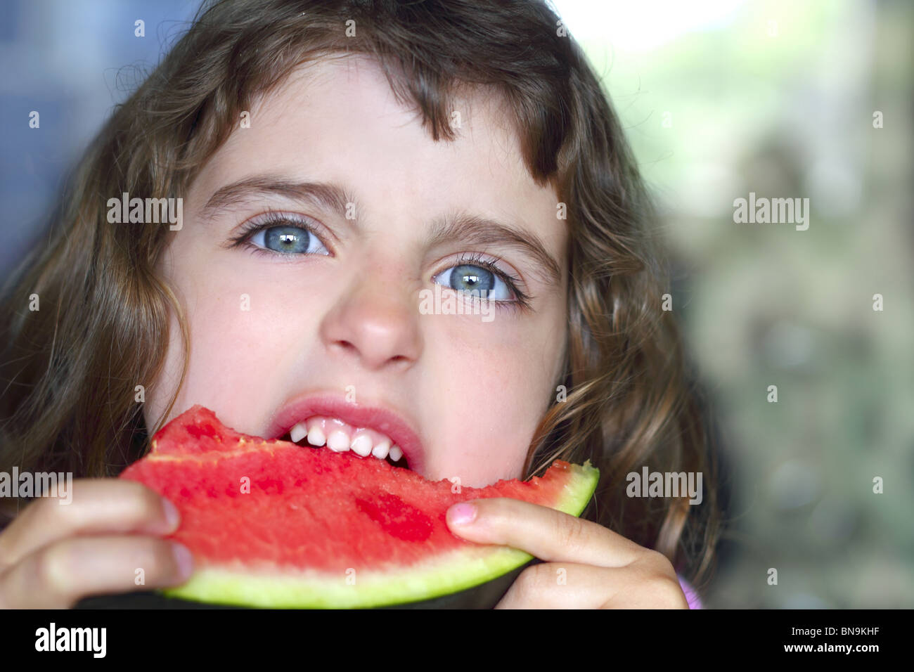 closeup little girl portrait eating watermelon slice blue eyes Stock ...