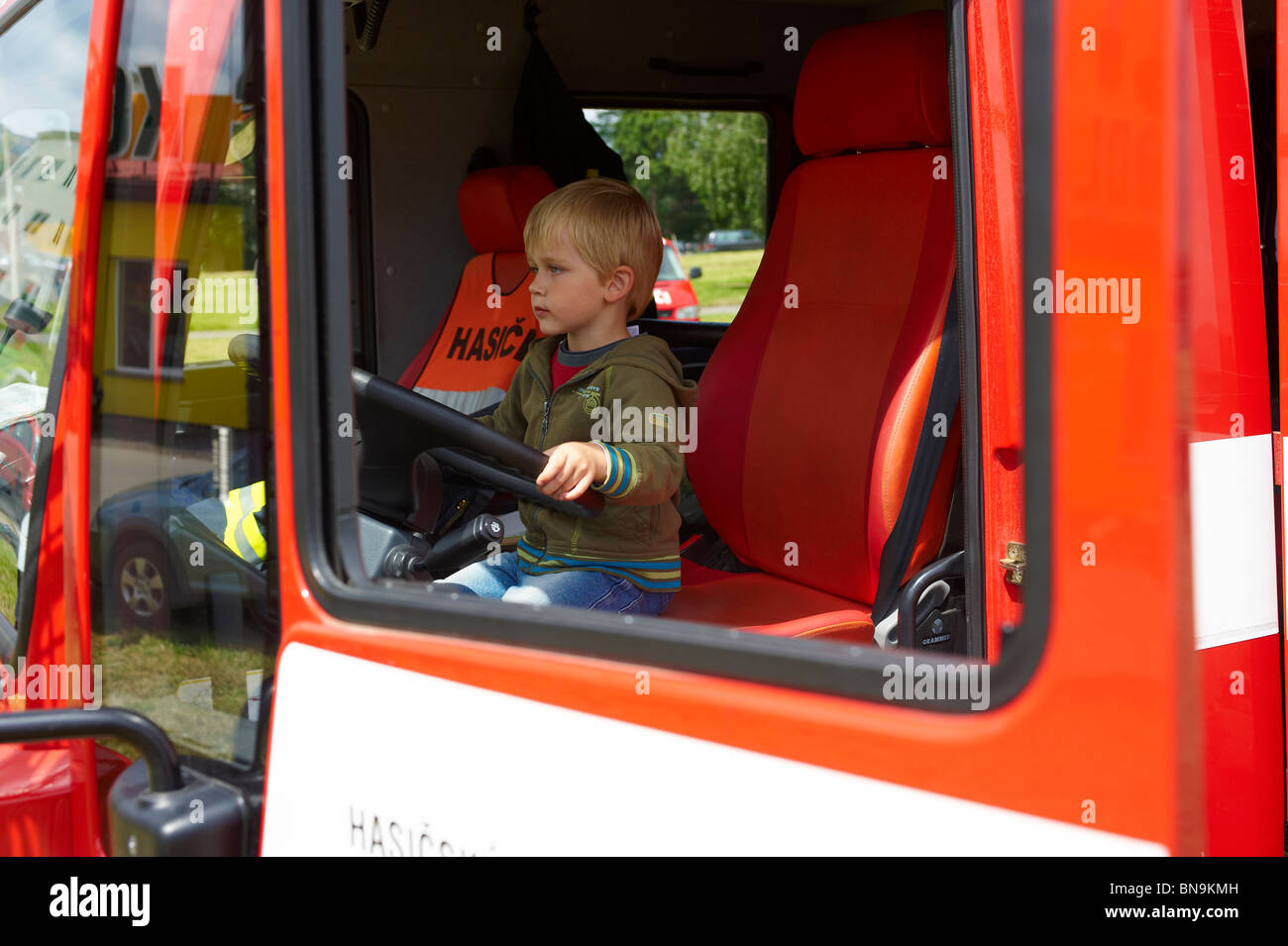 Young child boy playing fire fighter Stock Photo - Alamy