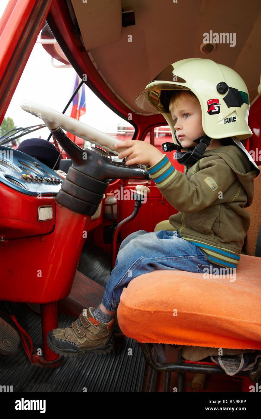 Young child boy playing fire fighter Stock Photo - Alamy