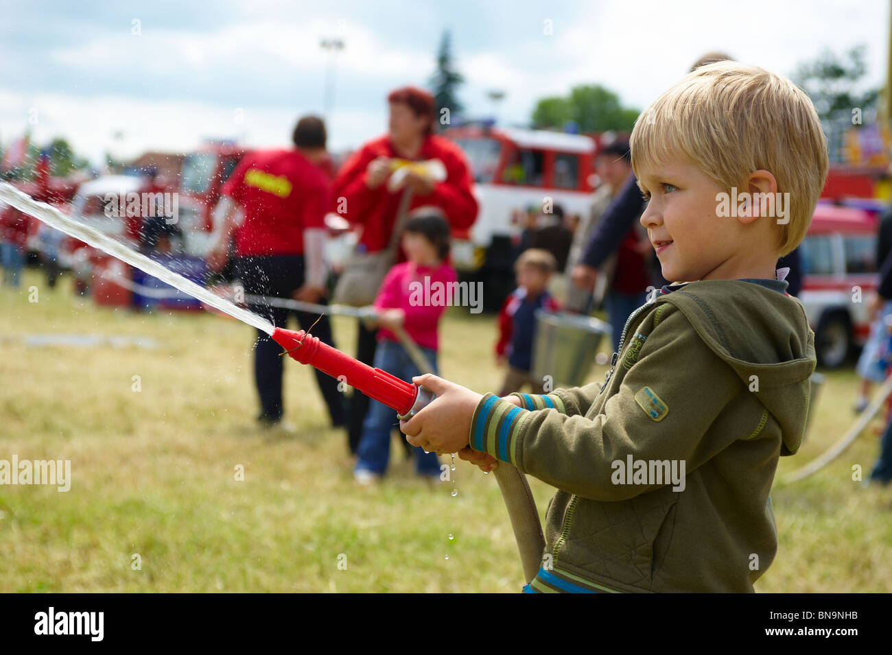 Young child boy playing fire fighter Stock Photo - Alamy