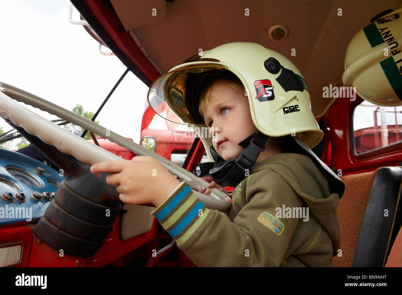 Young child boy playing fire fighter Stock Photo - Alamy