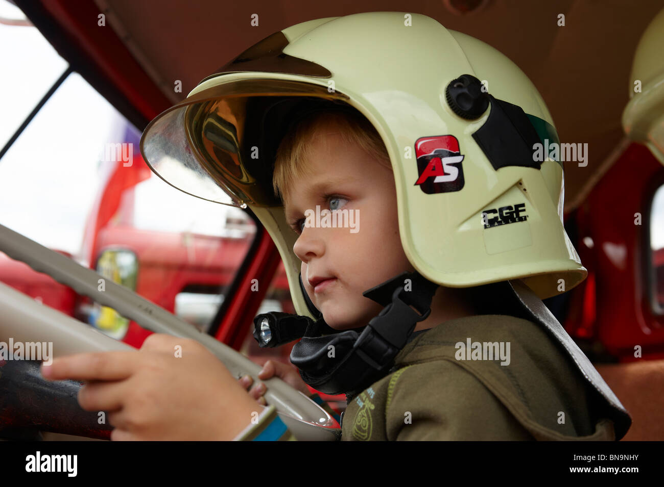 Young child boy playing fire fighter Stock Photo - Alamy