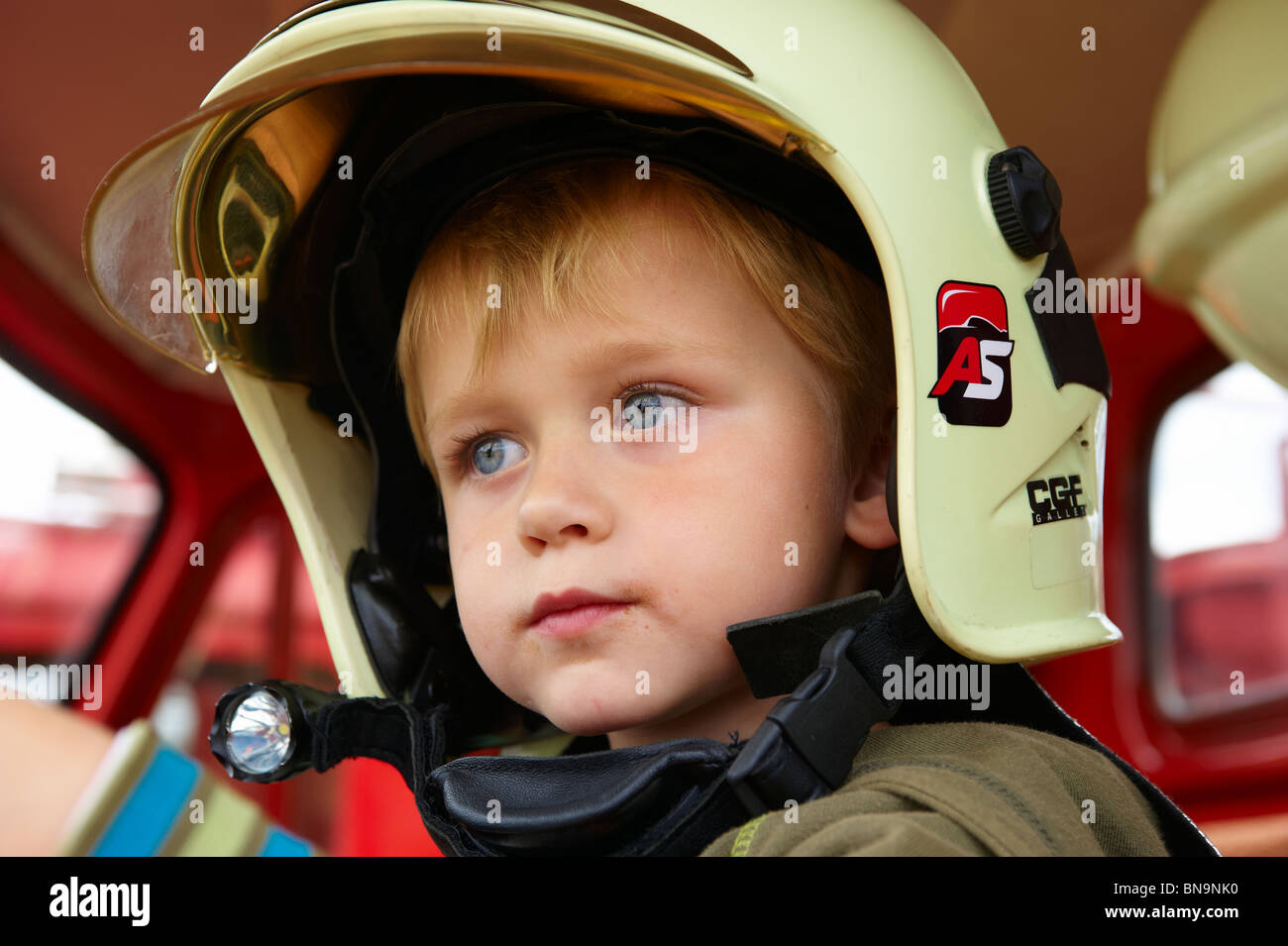 Young child boy playing fire fighter Stock Photo - Alamy