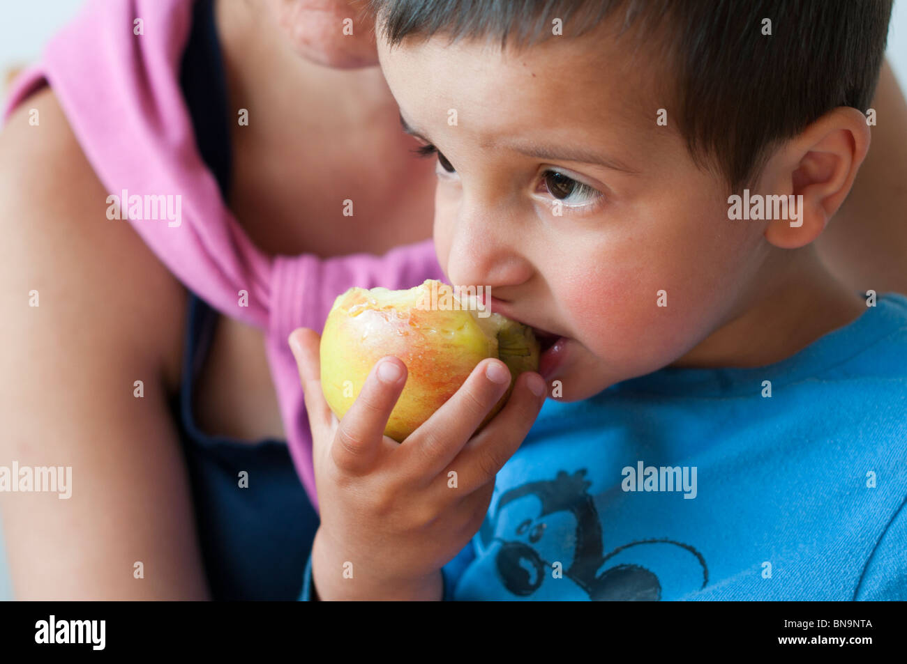 Child eating an apple-close-up Stock Photo - Alamy