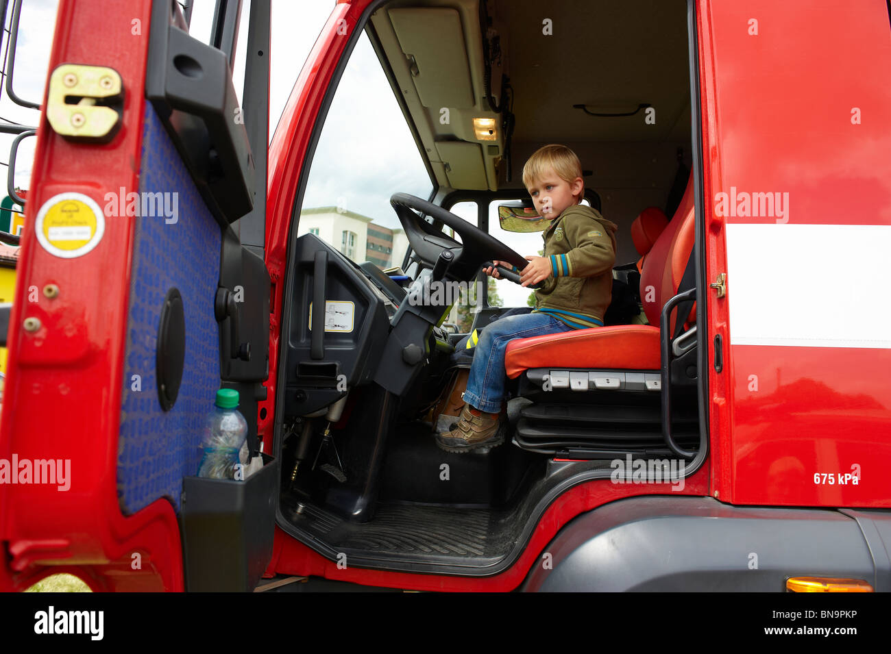 Young child boy playing fire fighter Stock Photo - Alamy