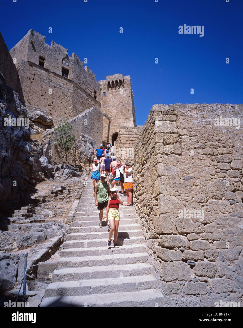 Visitors climbing the steps on the Acropolis of Lindos Stock Photo - Alamy