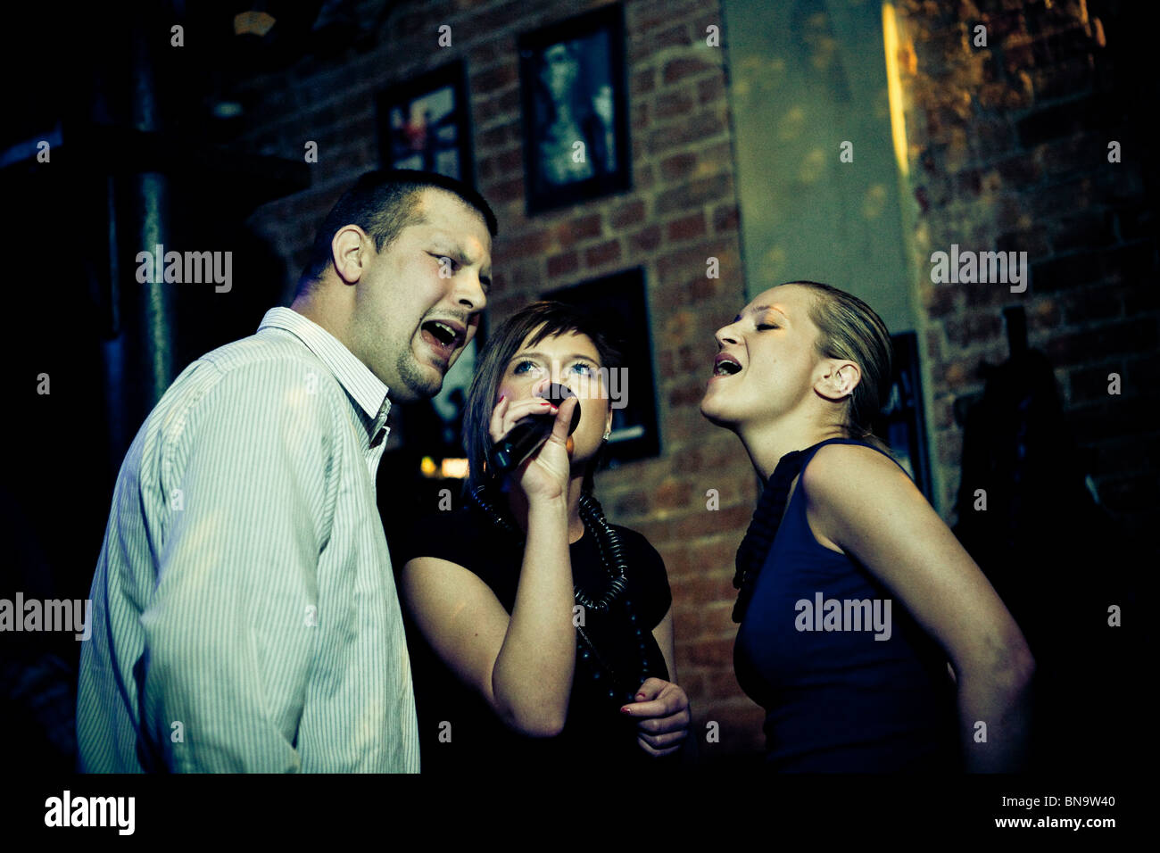 People singing karaoke at a bar Stock Photo - Alamy