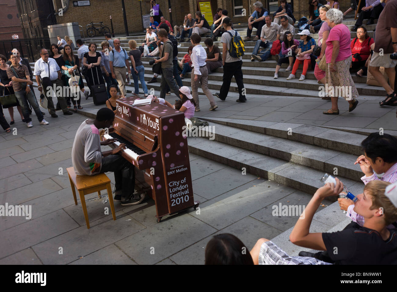 Crowds are entertained by pianist playing as part of City of London's ...