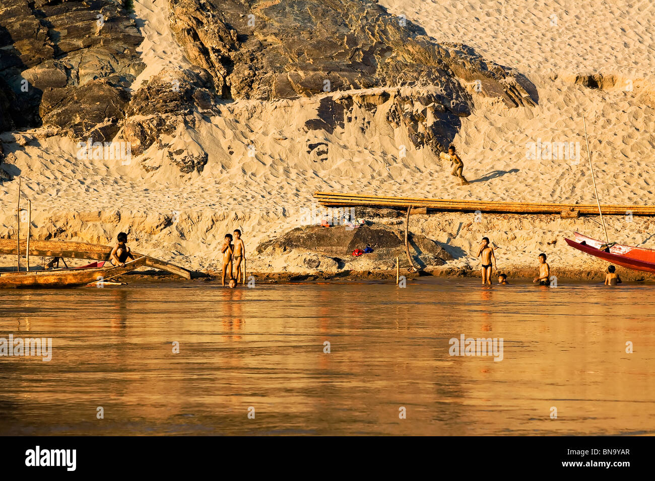 Kids playing on the bank of the Mekong river, Laos Stock Photo - Alamy