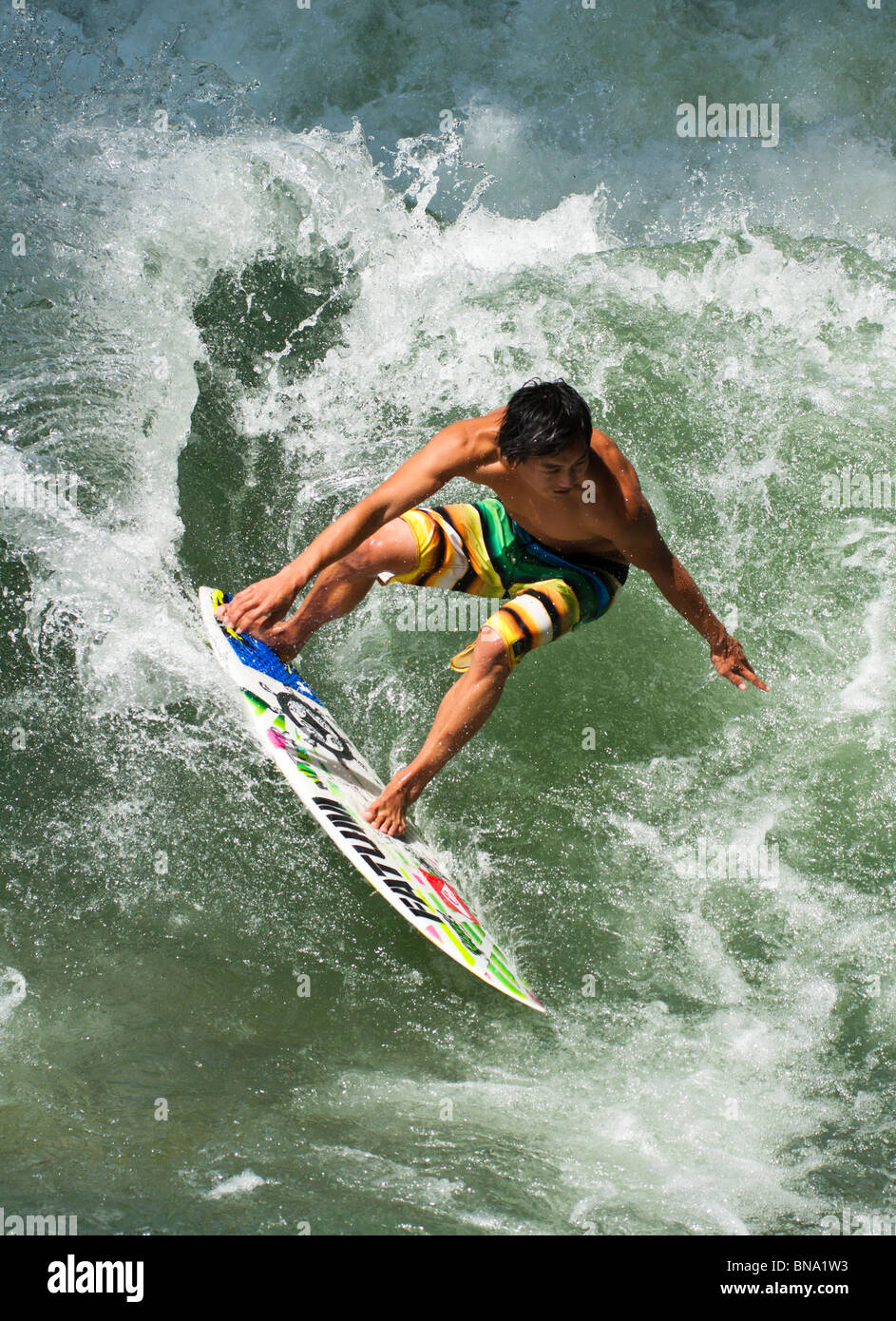 Surfer riding a wave Stock Photo - Alamy