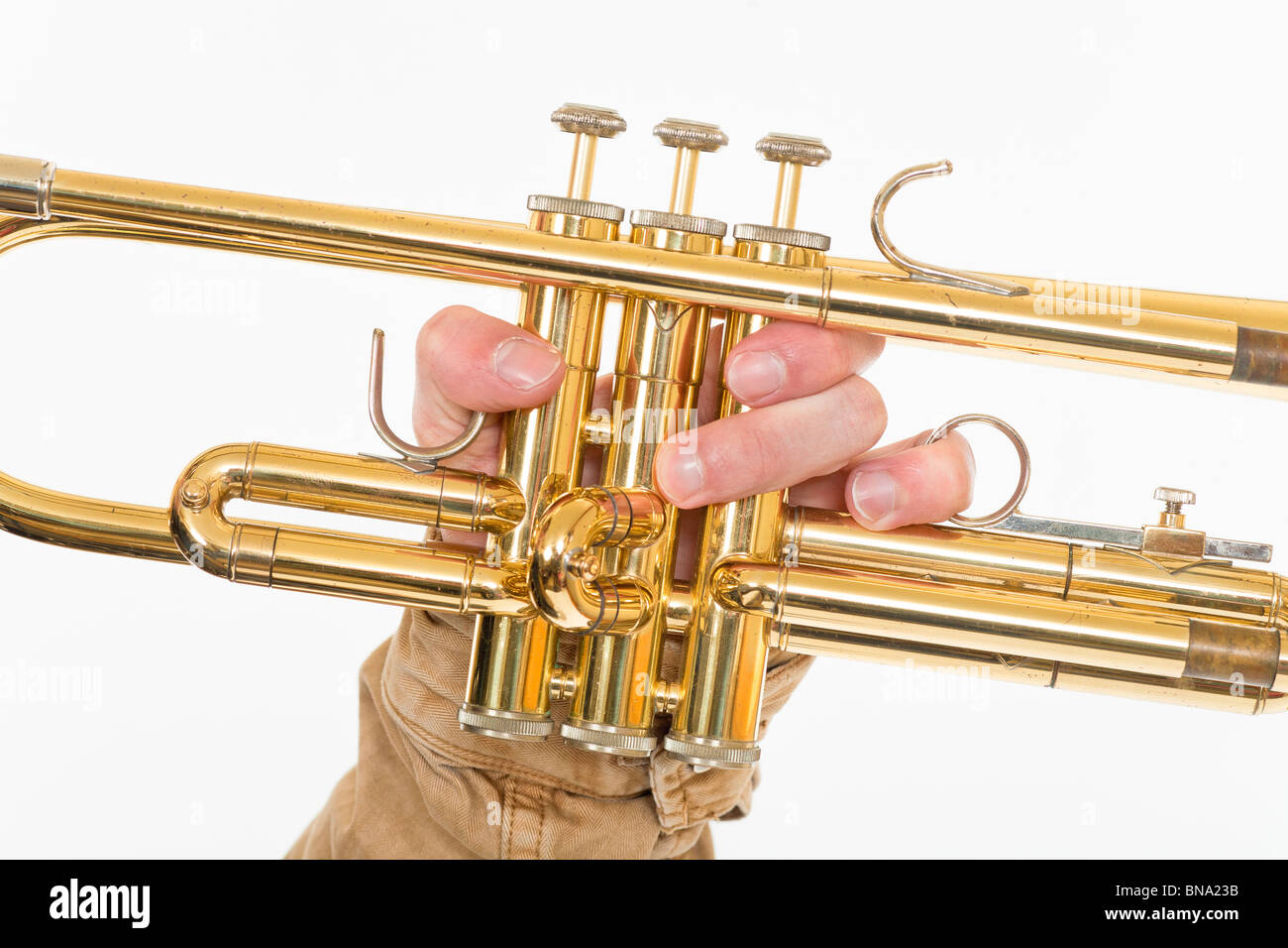 Closeup of hands holding a trumpet Stock Photo - Alamy