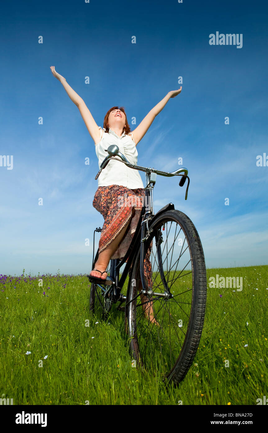 Happy young woman relaxing over a vintage bicycle Stock Photo - Alamy