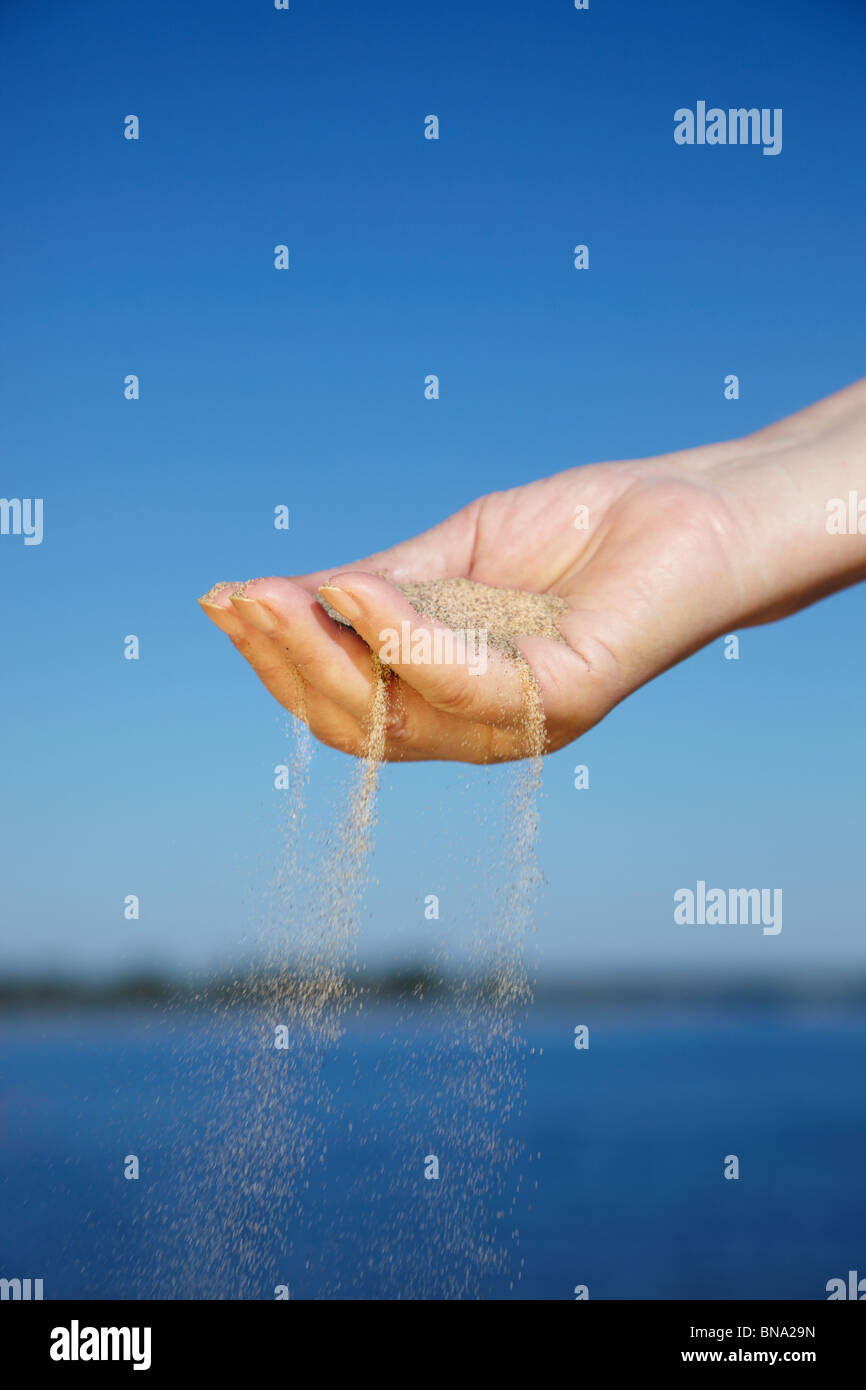 Sand falling from woman's hand, selective focus on nearest part Stock ...