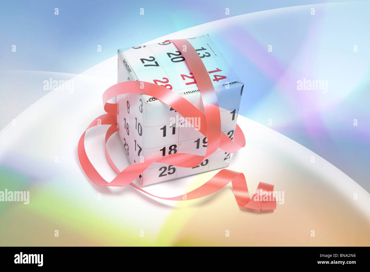 Gift Parcel Wrapped with Calendar Paper Stock Photo - Alamy