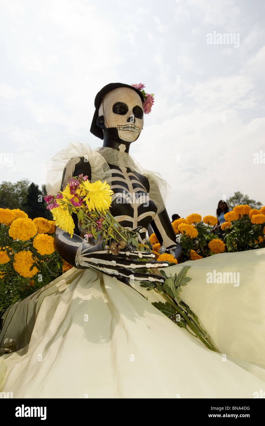 Catrina holding some cempasuchil flowers and a bottle of tequila in a ...