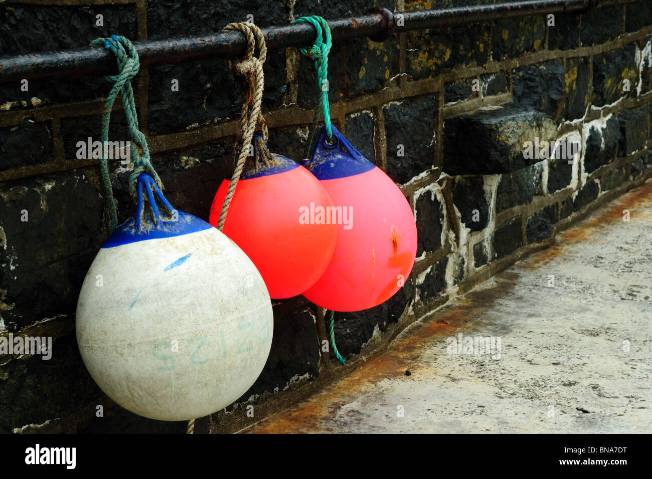 Fishing Buoys on the Harbour Wall Stock Photo - Alamy