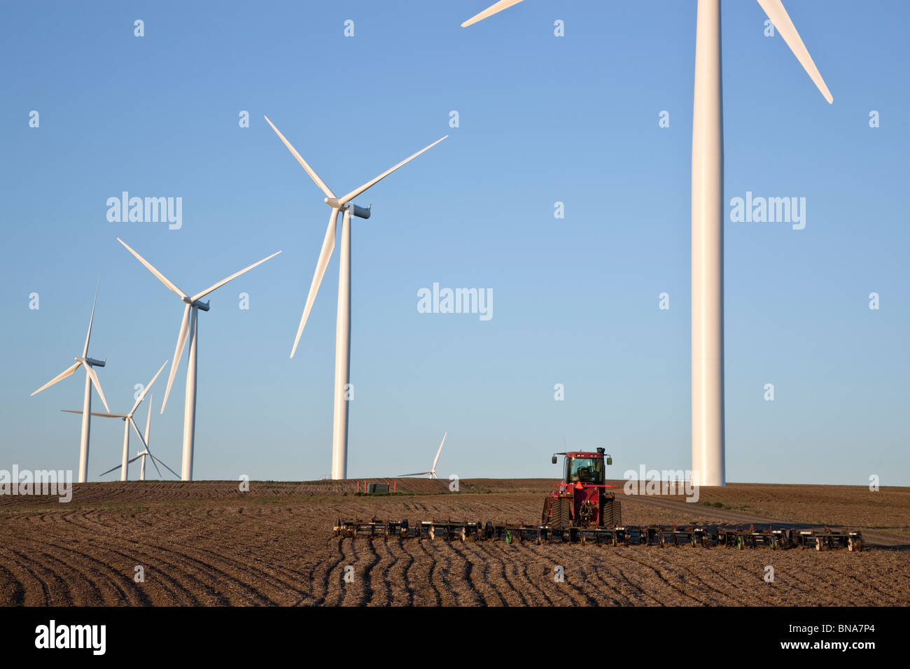 Tractor dragging harrow, fallow wheat field, wind farm Stock Photo - Alamy