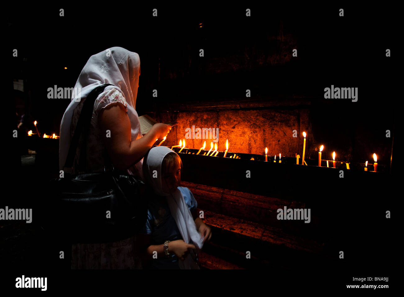 A Christian devotee praying during a procession inside the Church of ...
