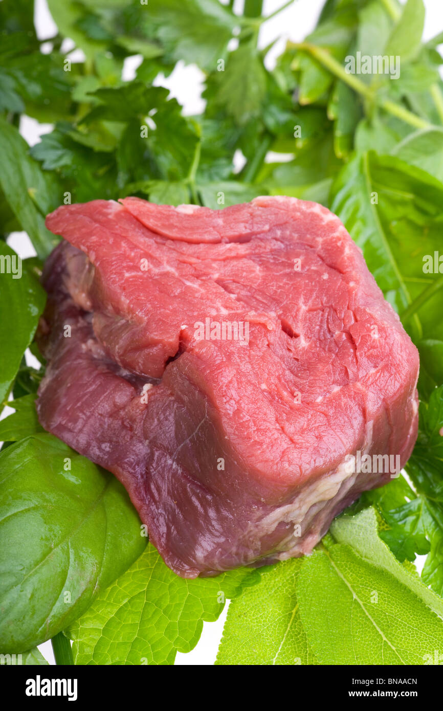 raw fillet steak on mixed herbs Stock Photo - Alamy