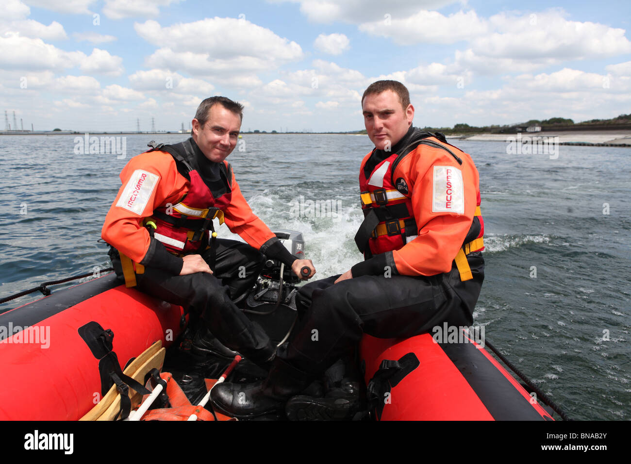 fireman training to save a person who is drowning in open water. they ...