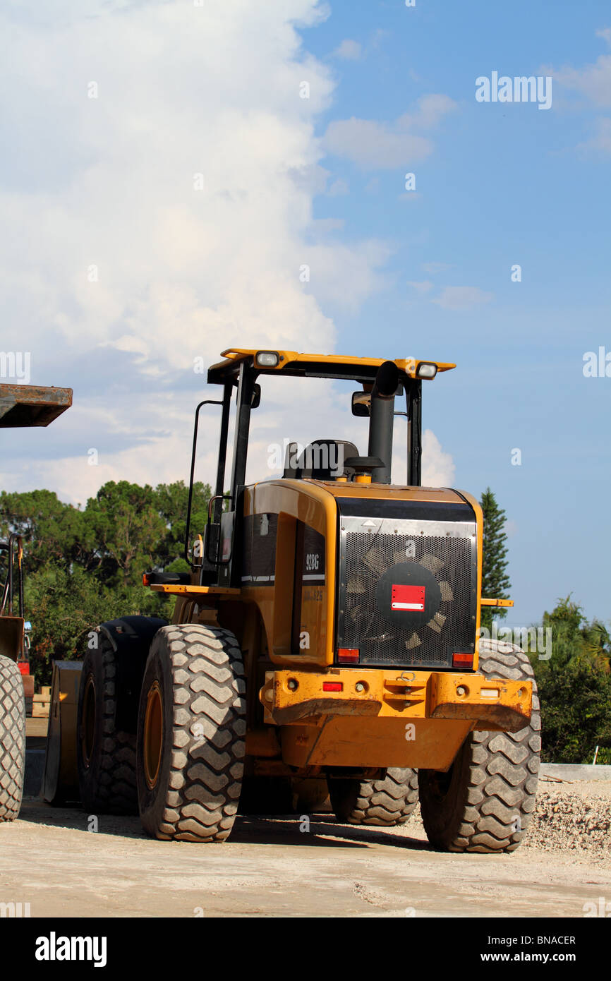 Yellow tractor is waiting for the next shift on construction site Stock ...
