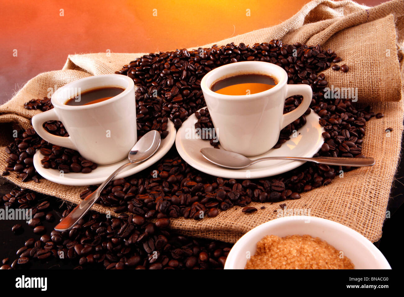 A couple of cups of coffee and grains on a sisal sack Stock Photo - Alamy