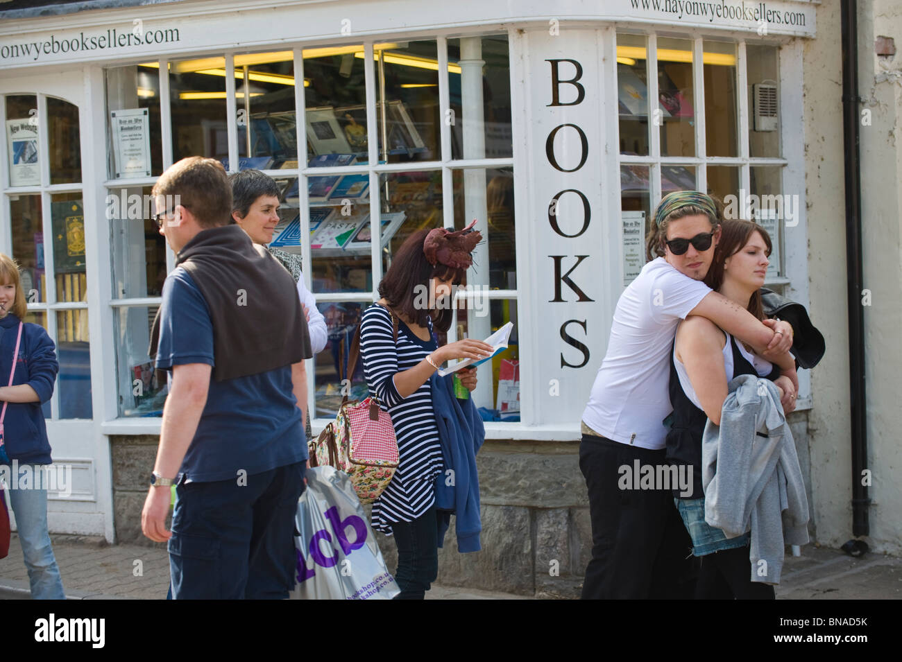 People waiting in queue outside bookshop in town centre of Hay on Wye ...